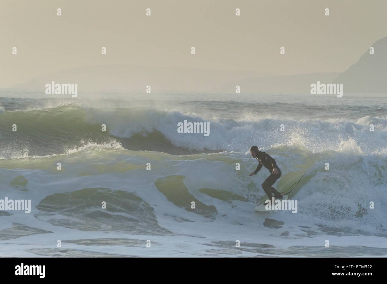 High winds fill the air with spray bringing good waves for surfers ...