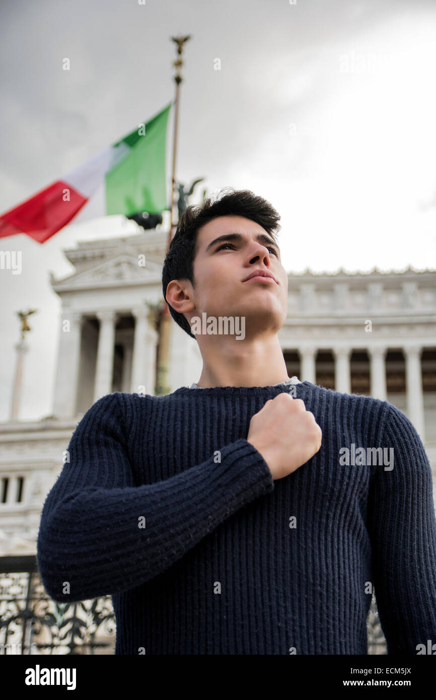 Proud young man in front of Italian flag with confident expression in ...