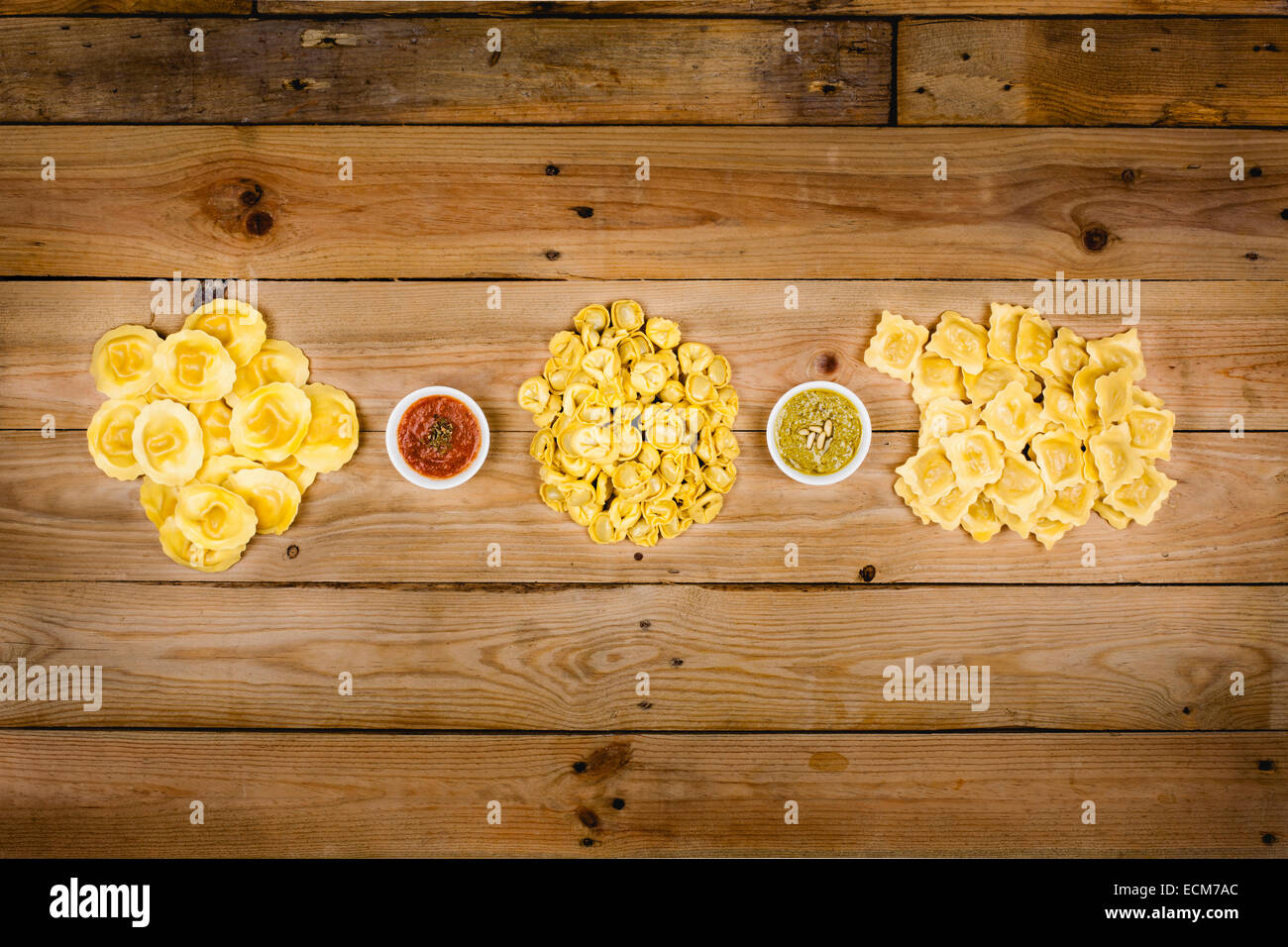 Three different types of fresh pasta with pesto and tomato sauce Stock ...
