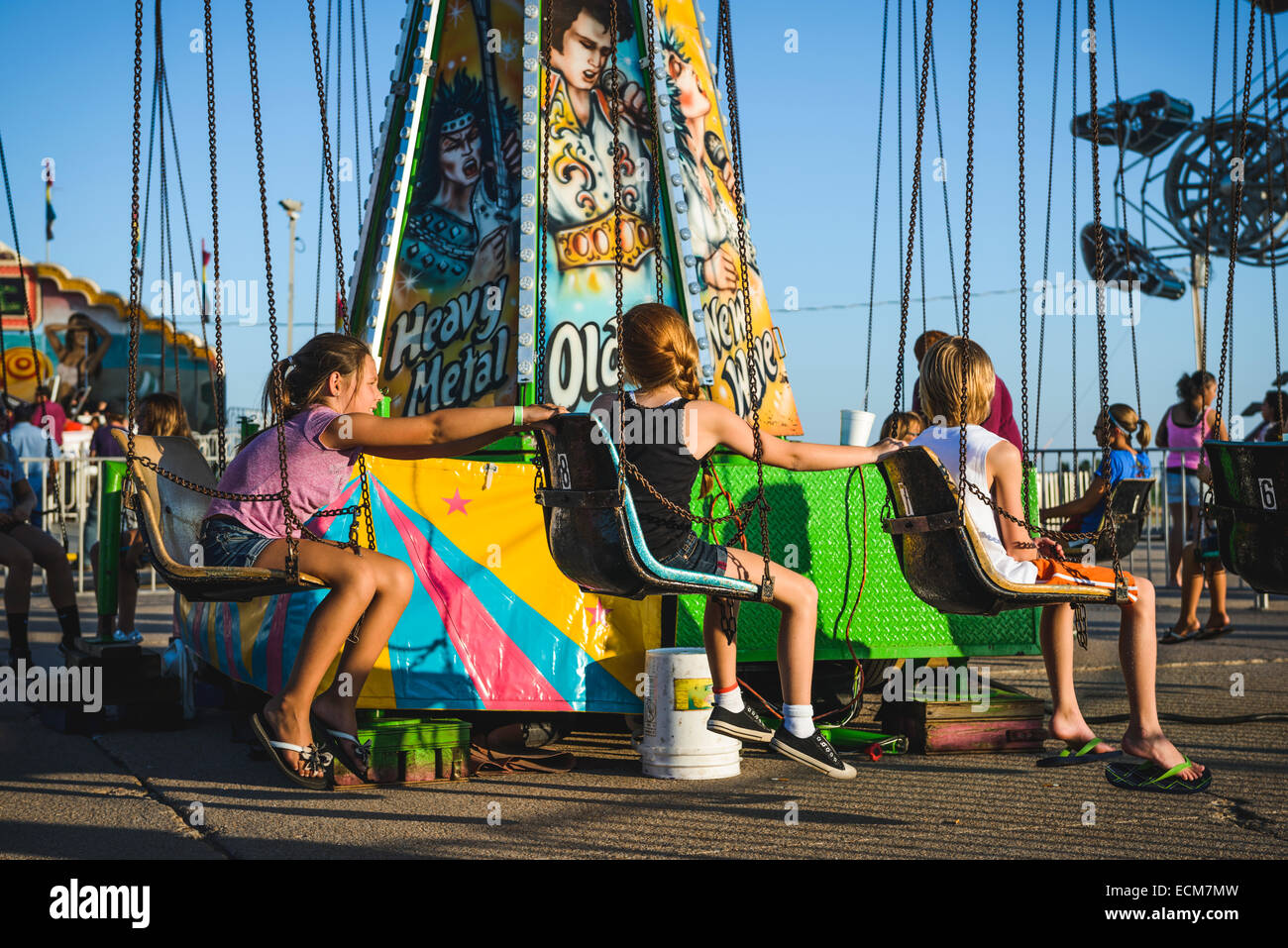 three kids on a carnival ride Stock Photo - Alamy