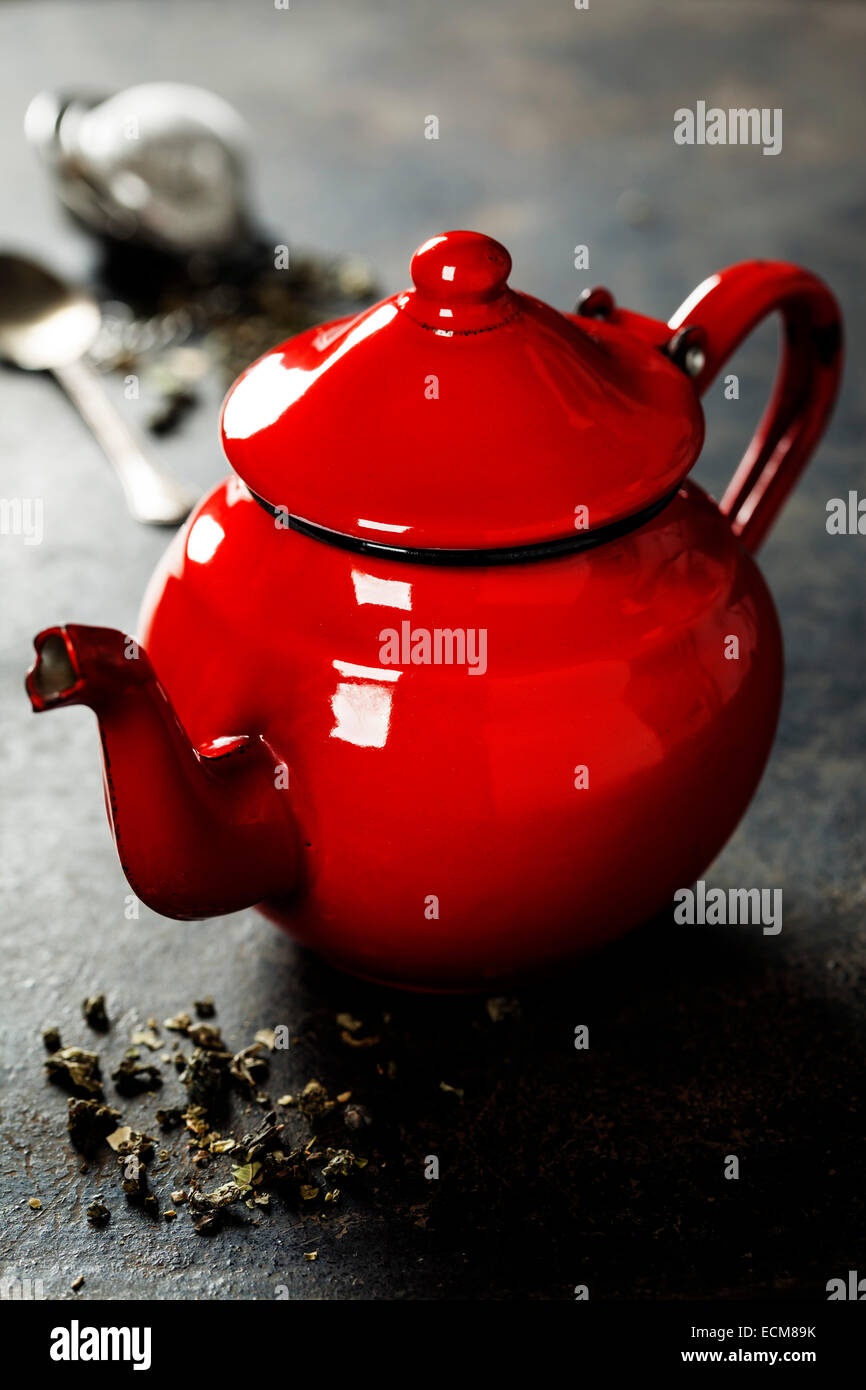 Tea composition with red teapot on dark background Stock Photo - Alamy