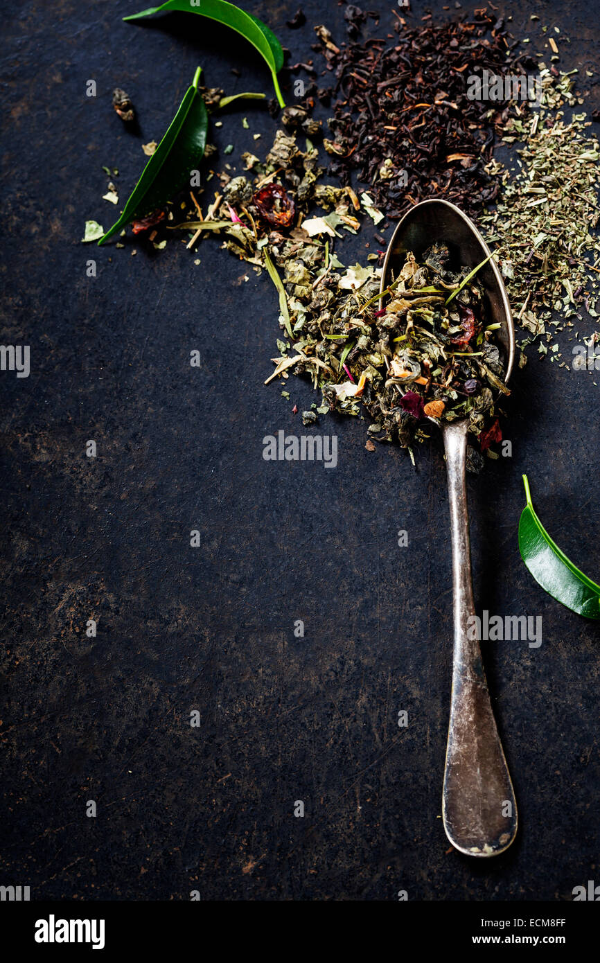 Tea composition with old spoon on dark background Stock Photo - Alamy