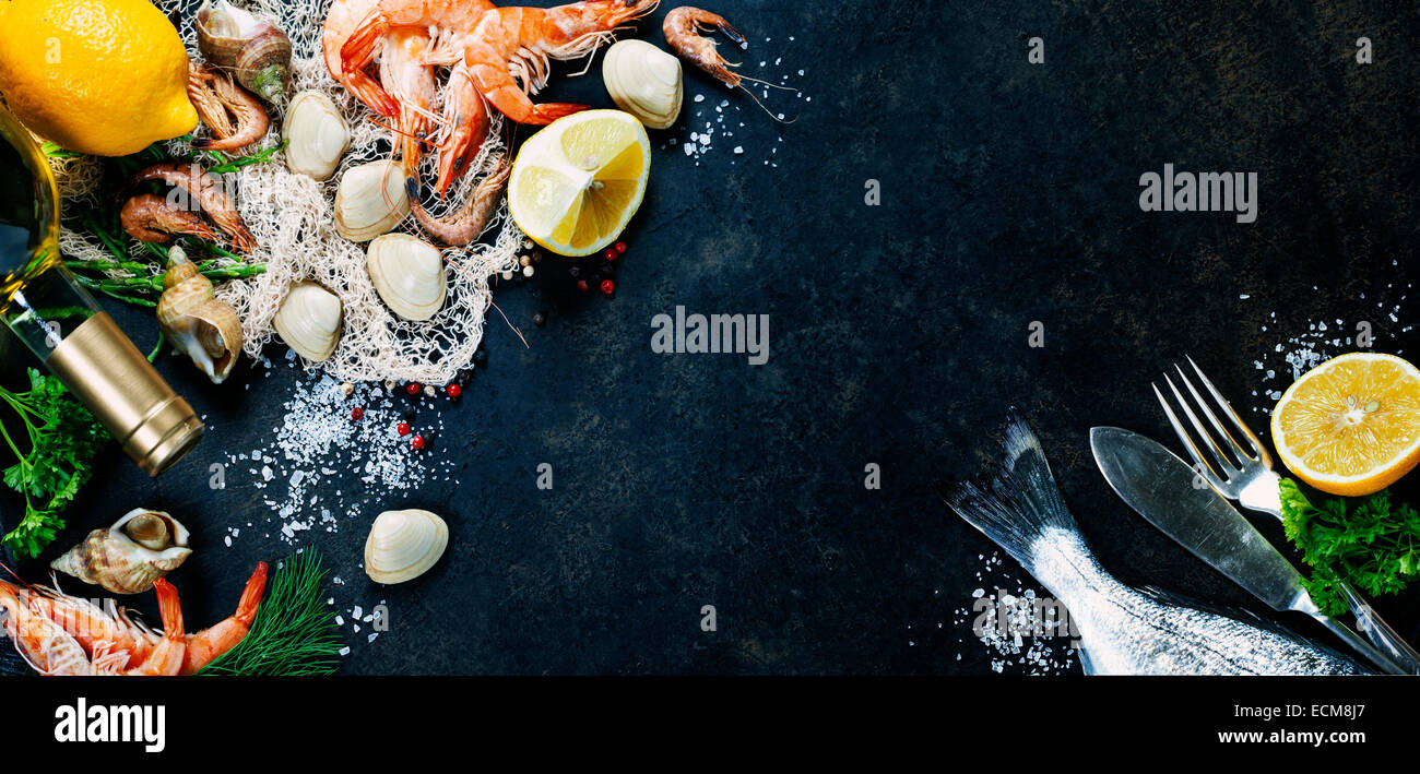 Delicious fresh fish and seafood on dark vintage background. Fish ...
