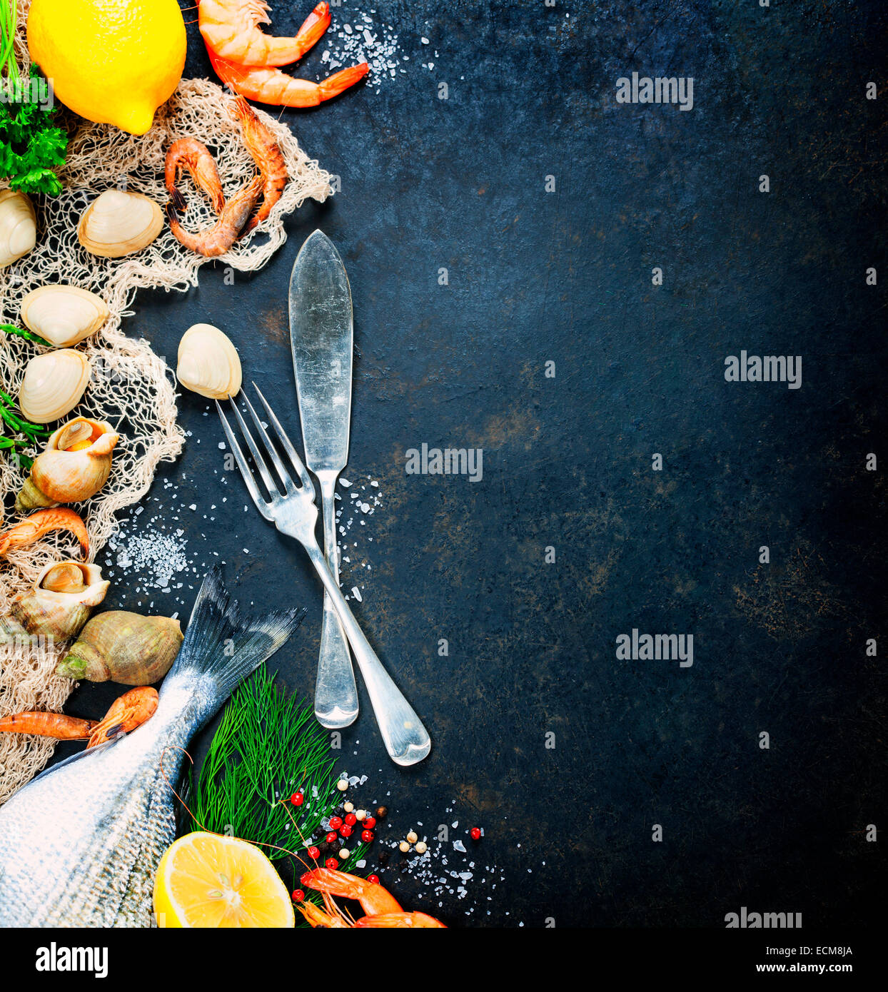 Delicious fresh fish and seafood on dark vintage background. Fish ...