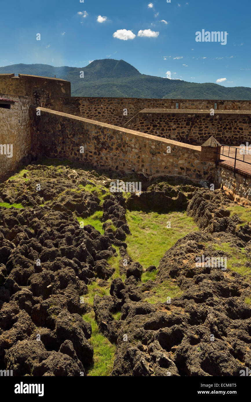 Fort San Felipe with lava rock moat and Isabel de Torres mountain ...