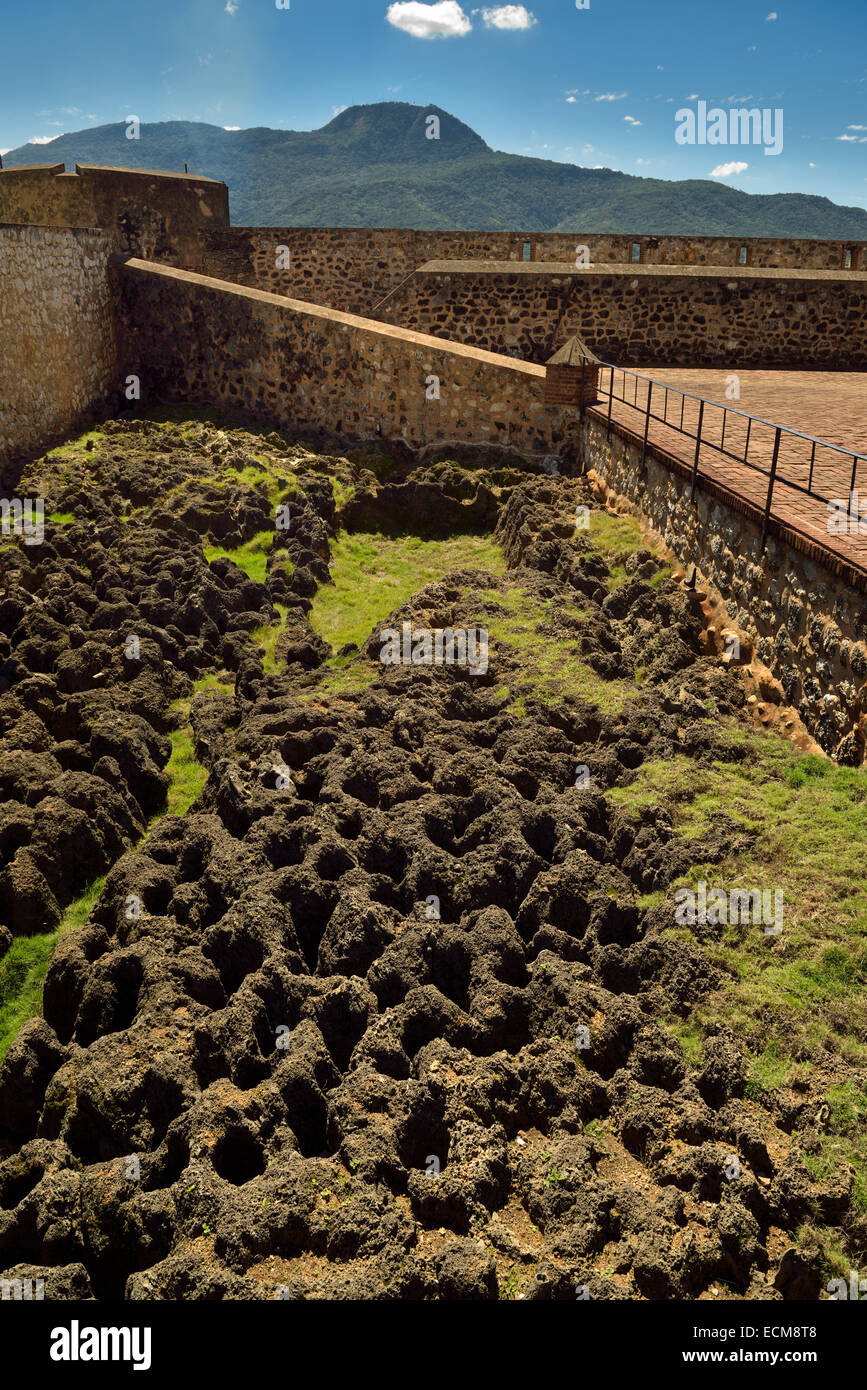 Fort St Philip with lava rock moat and Isabel de Torres mountain Puerto ...