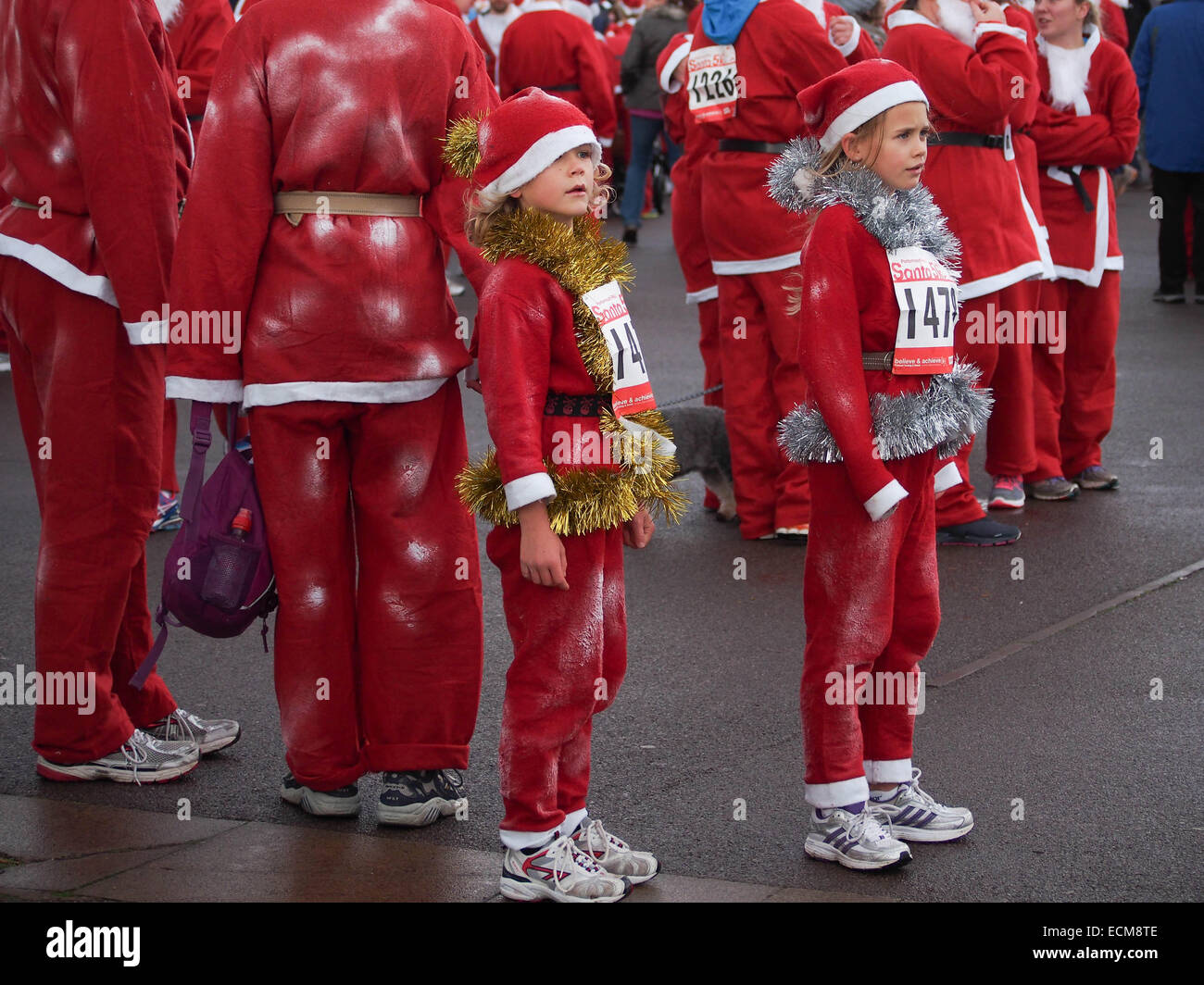 two young girlsdressed as Santa Clause take part in the Santa fun run ...