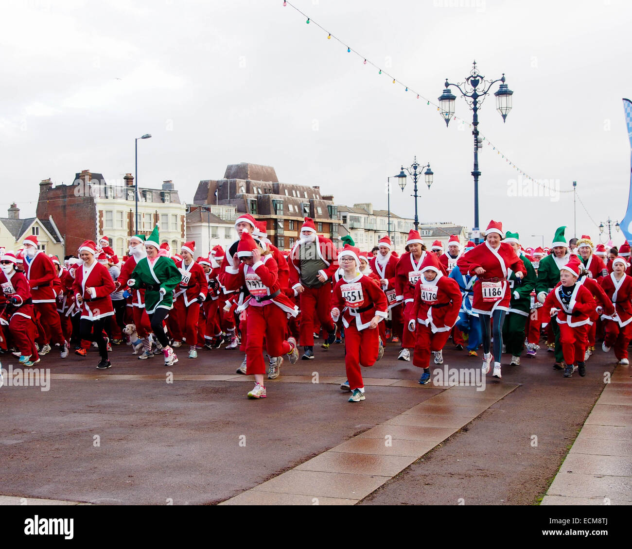 Runners dressed as Santa Clause take part in the Santa fun run in ...