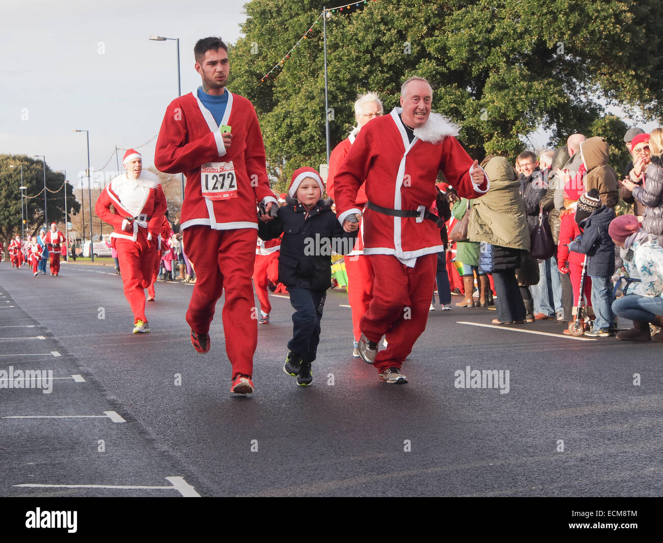 Participants dressed as Santa Clause take part in the Santa fun run in ...