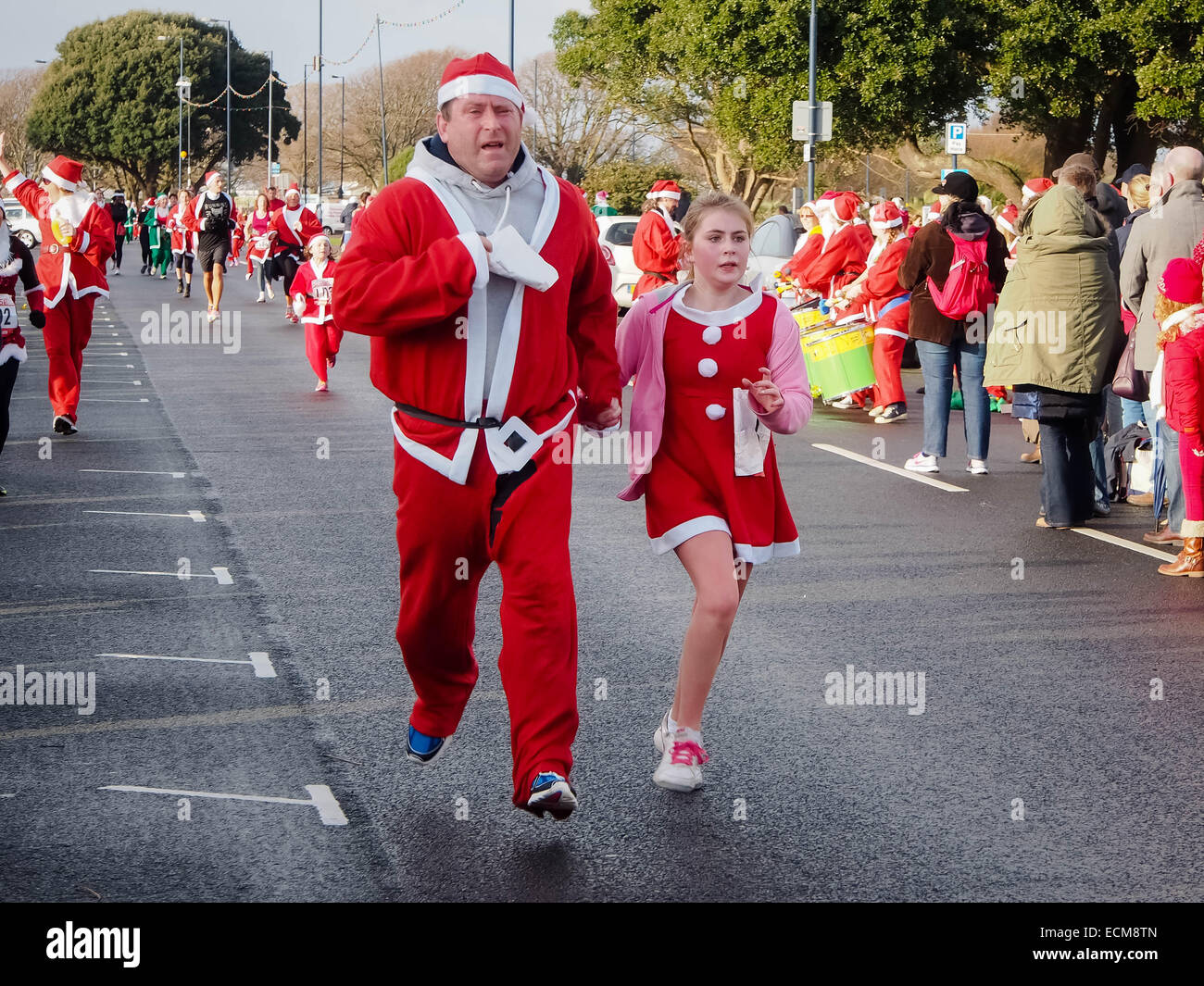 Participants dressed as Santa Clause take part in the Santa fun run in ...