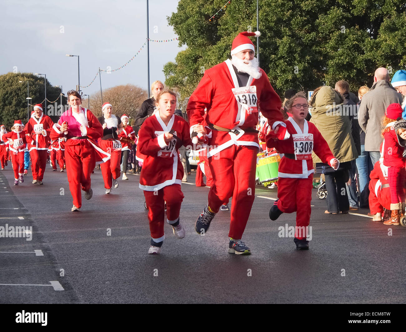 Participants dressed as Santa Clause take part in the Santa fun run in ...
