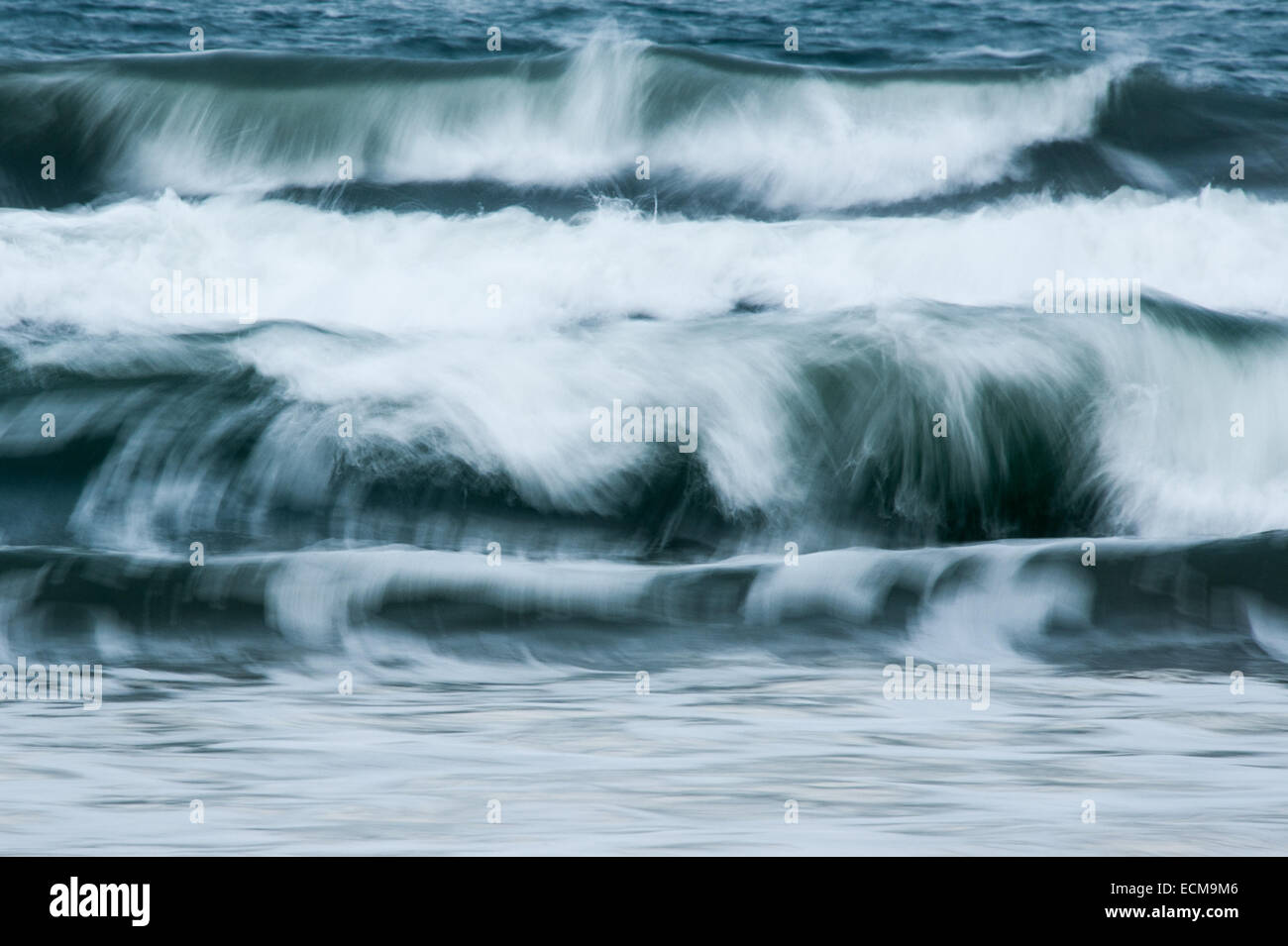 A slow exposure of waves breaking onto a beach in England Stock Photo ...