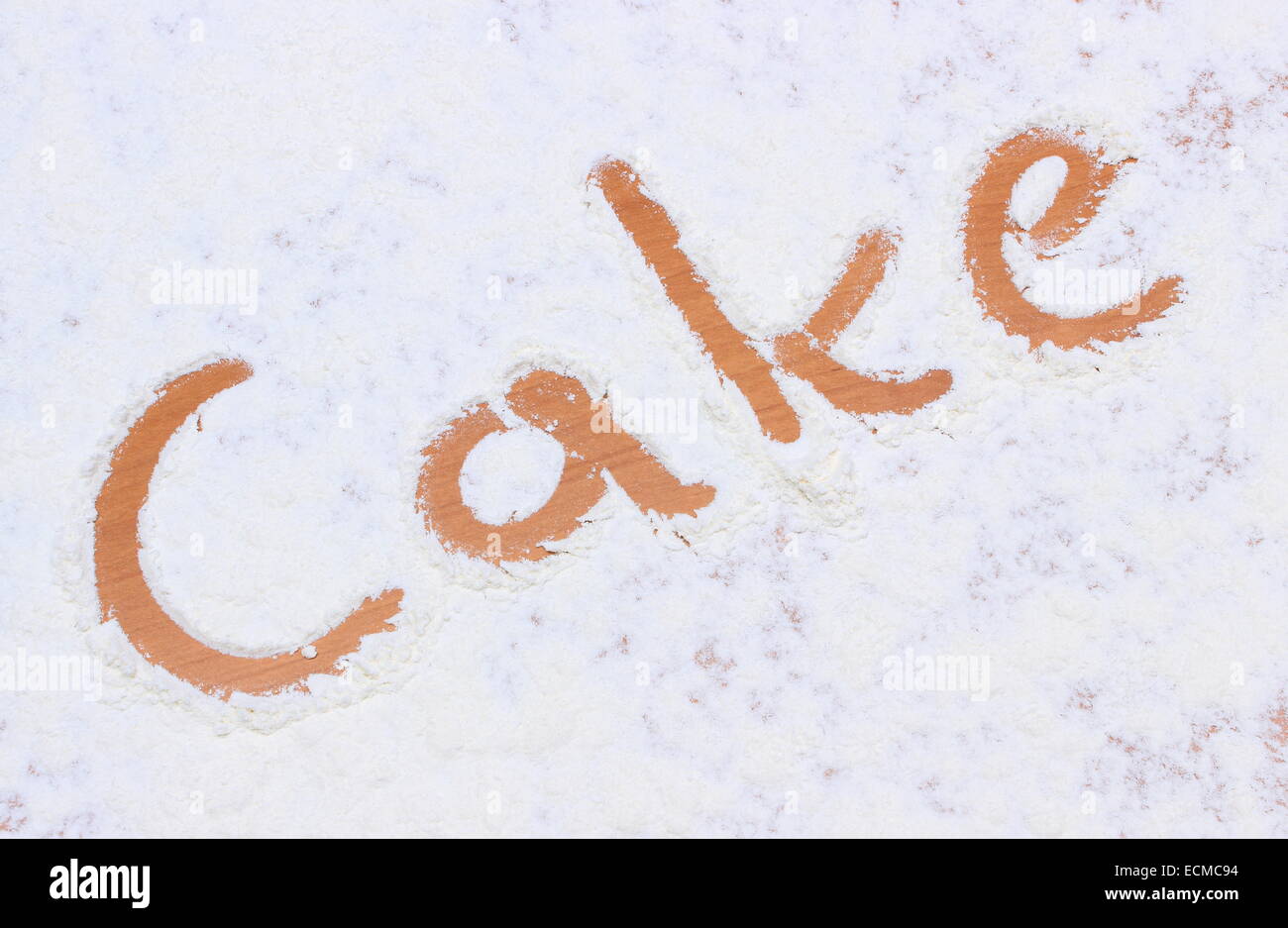 Word cake written in white flour, concept for baking Stock Photo - Alamy