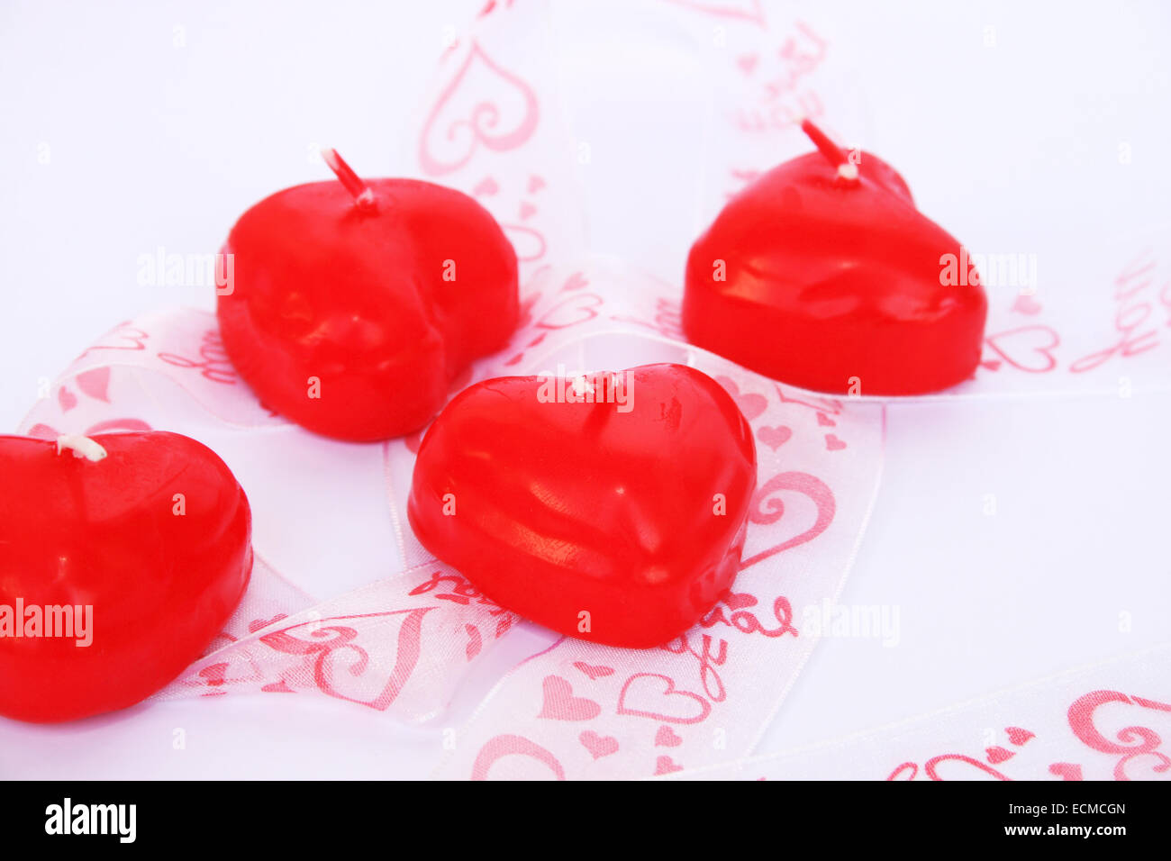 Heart shape red candles and ribbon isolated on gray background Stock ...