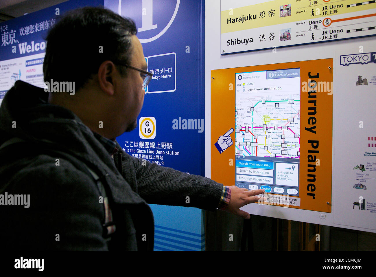 A man uses a subway information touch panel guide "Journey Planner" at ...