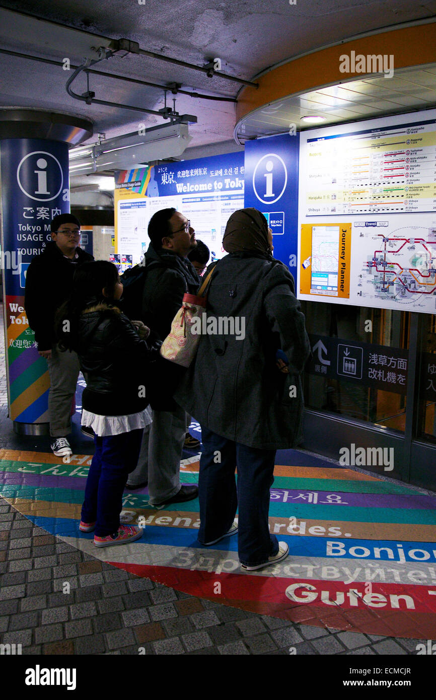 People watch a subway information board with a touch panel guide ...