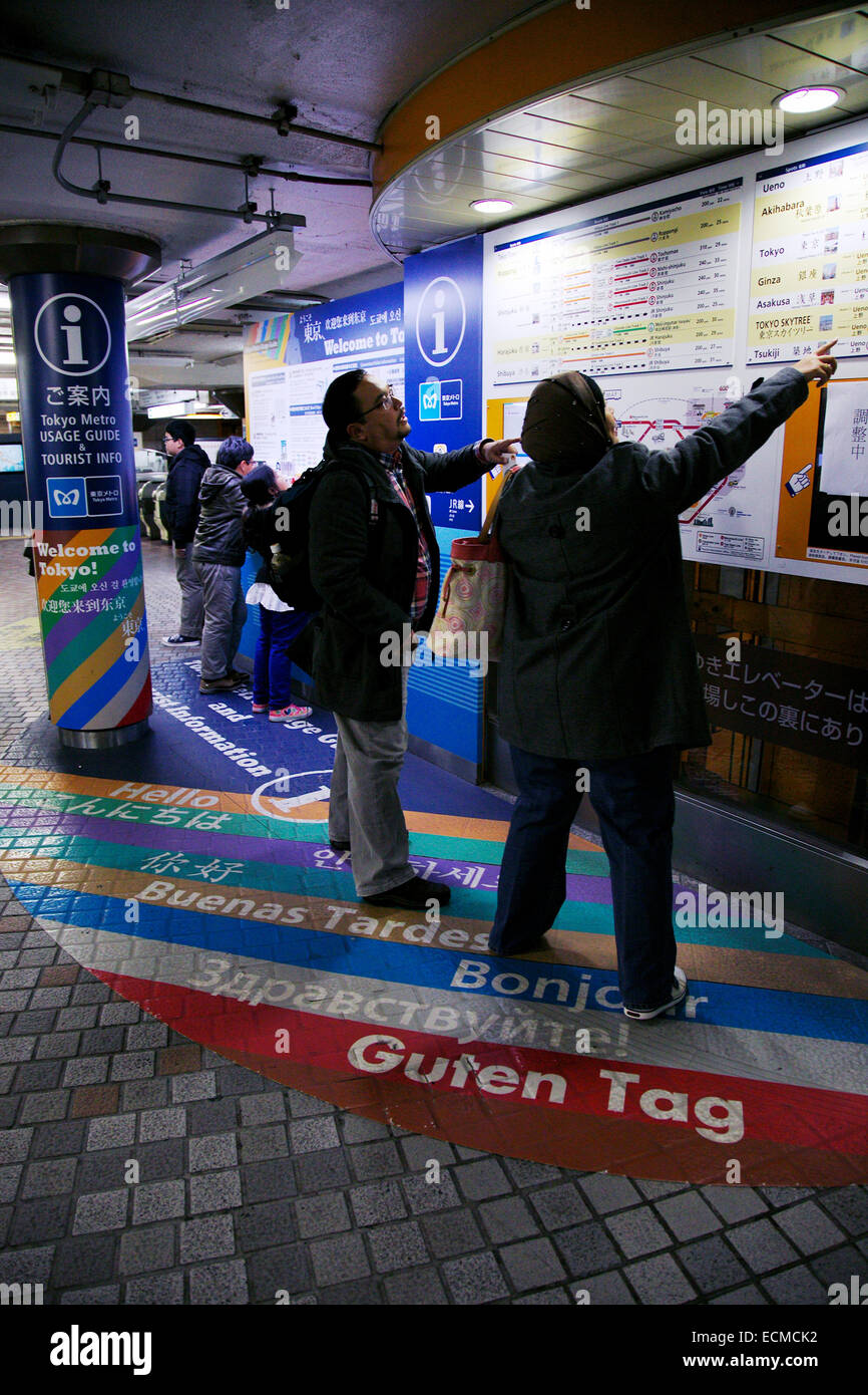 People watch a subway information board with a touch panel guide ...