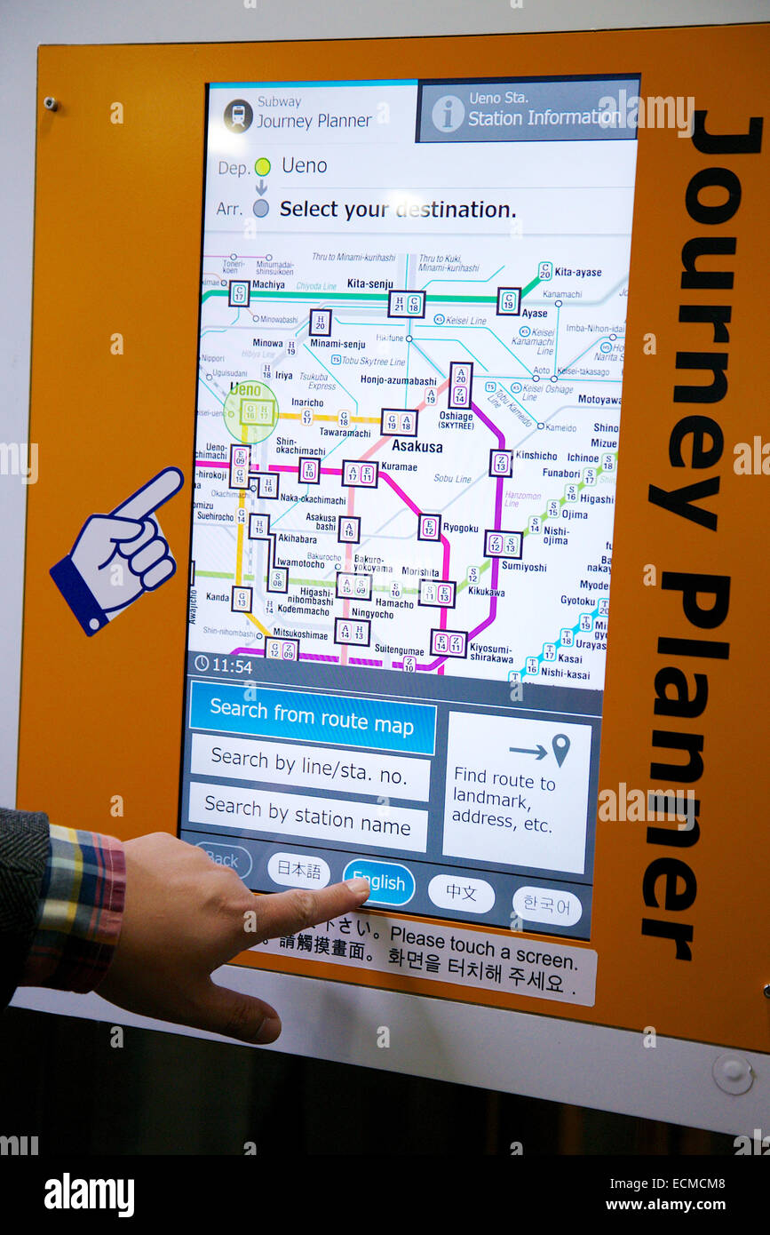 A man uses a subway information touch panel guide "Journey Planner" at ...