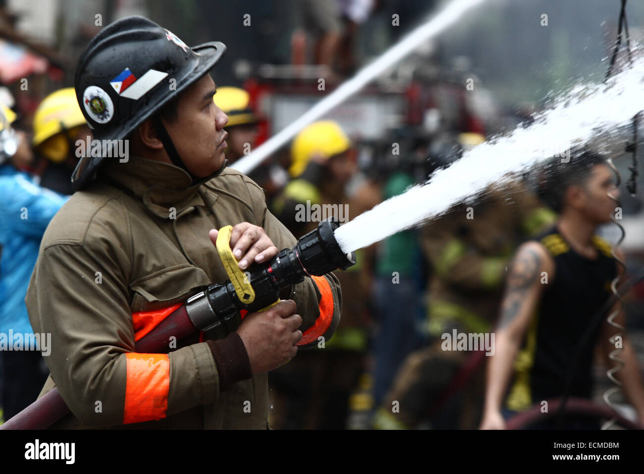 Quezon City, Philippines. 17th Dec, 2014. A firefighter tries to put ...