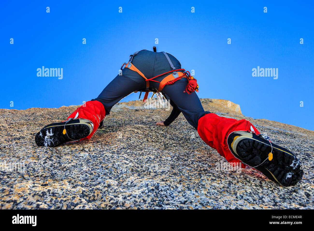 Climber climbing on a rock wall, alpine climb, Alps, below the summit ...