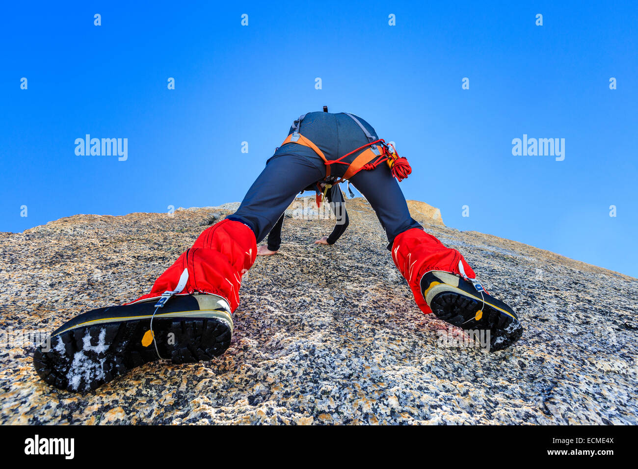 Climber climbing on a rock wall, alpine climb, Alps, below the summit ...