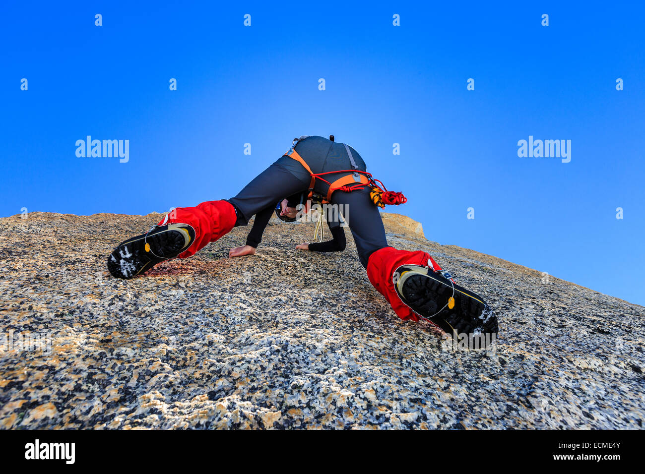 Climber climbing on a rock wall, alpine climb, Alps, below the summit ...