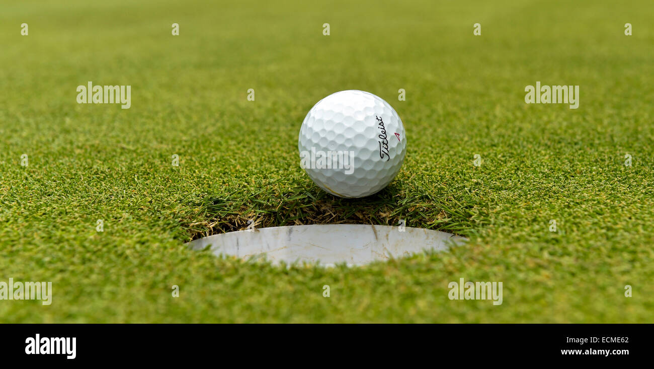 Golf ball rolling into the hole, Hua Hin, Thailand Stock Photo - Alamy