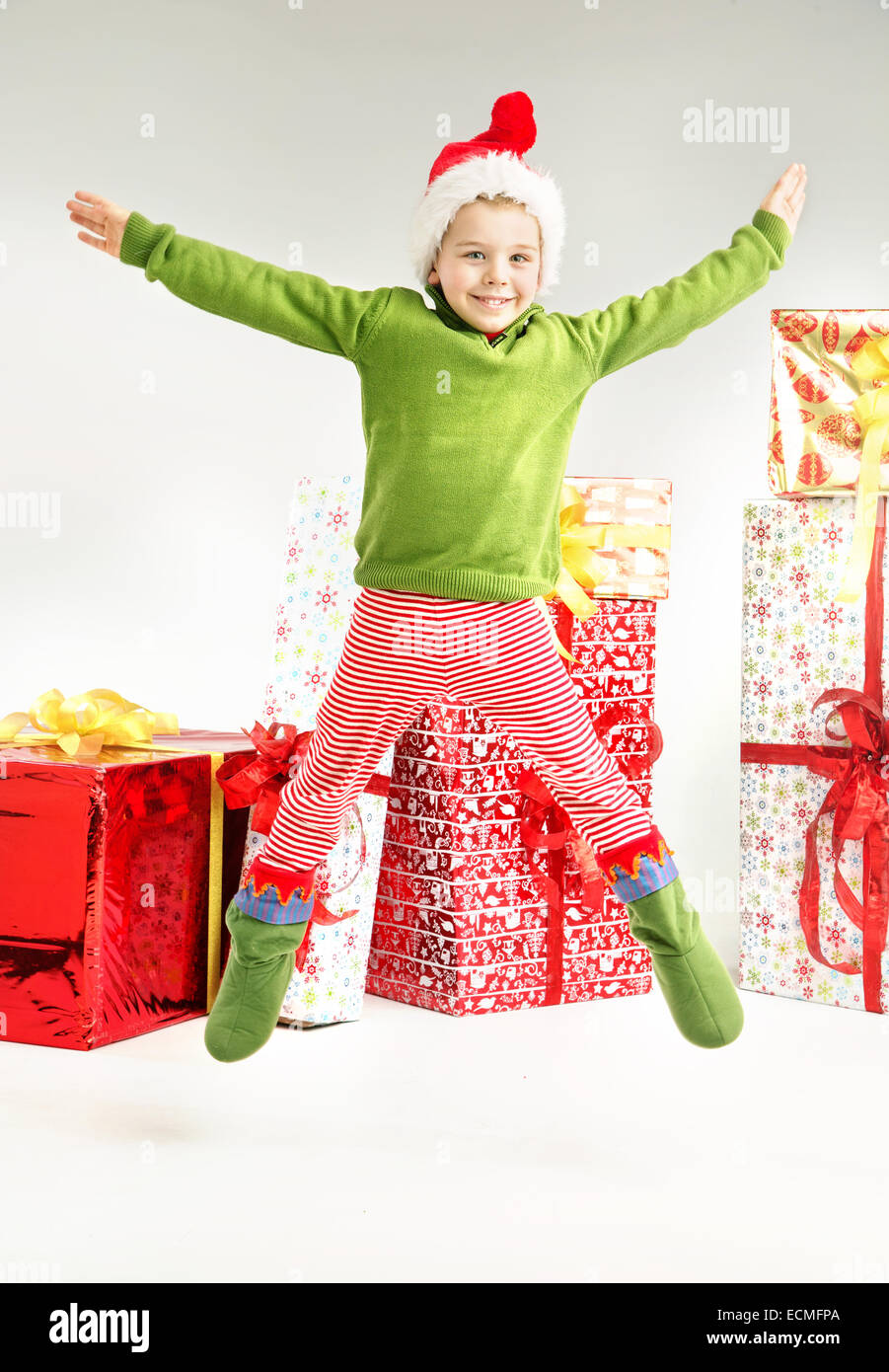 Cute jumping elf with gift in the background Stock Photo - Alamy