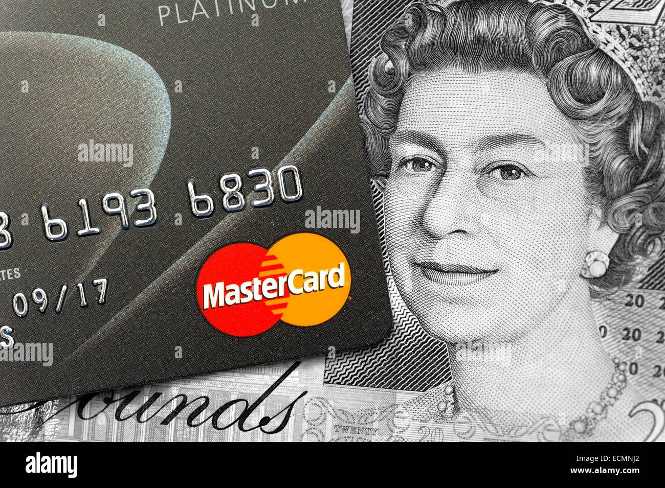 A master card next to the queen head on an English twenty pound note ...