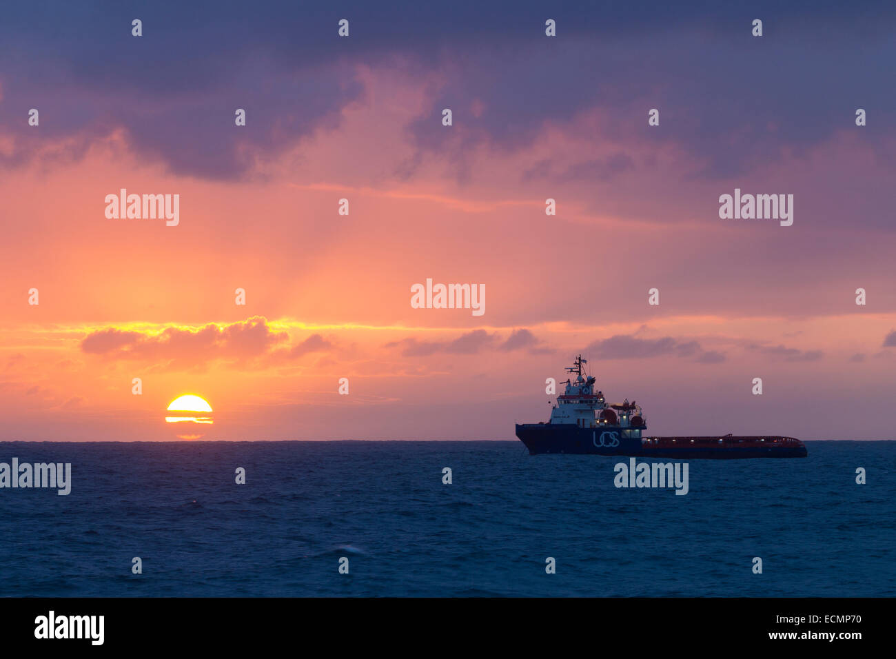 Tug boat at sunrise Stock Photo - Alamy