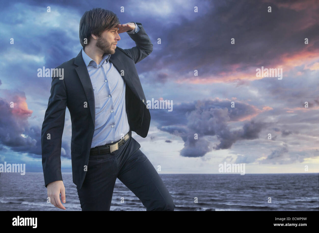 Smart young man observing the horizon Stock Photo - Alamy