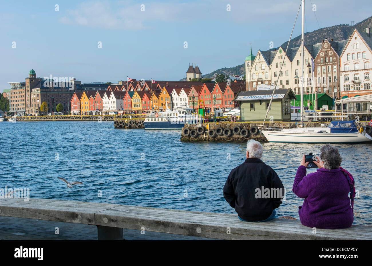 Bergen Norway Bryggen old town couple taking cell phone picture of ...