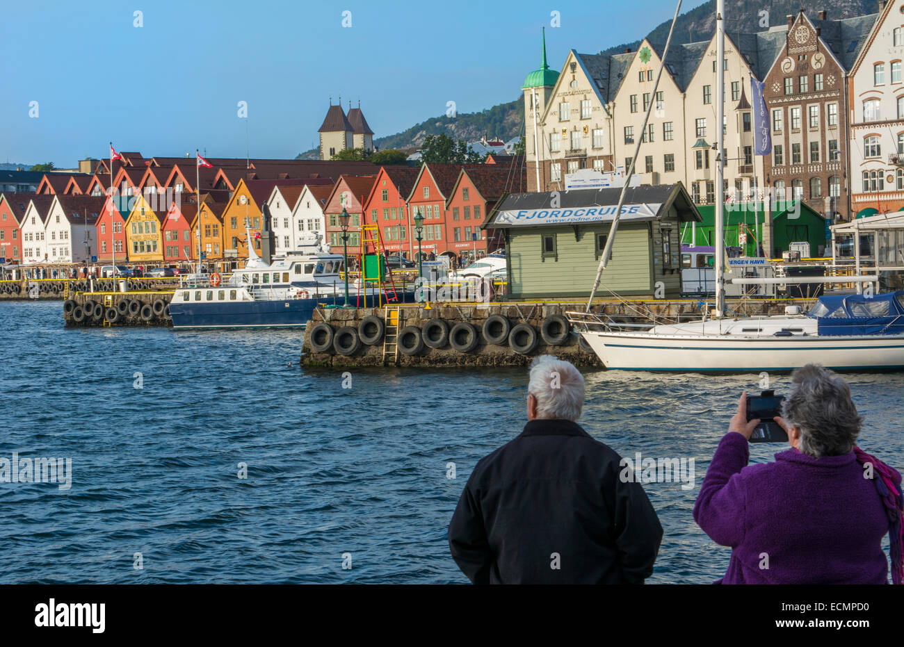 Bergen Norway Bryggen old town couple taking cell phone picture of ...