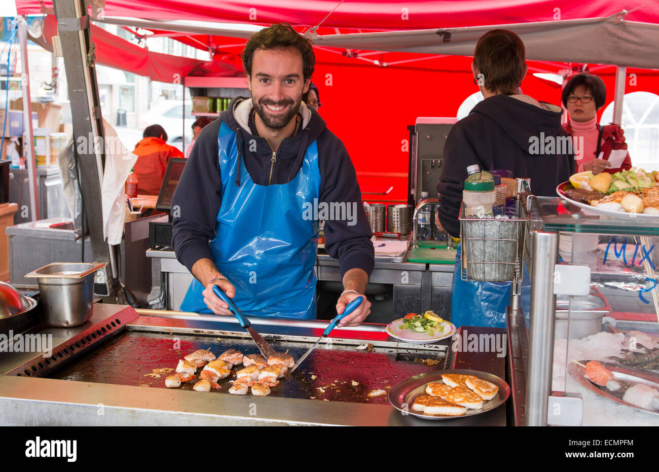 Bergen Norway seafood outdoor cafe cook prepares seafood for tourists ...