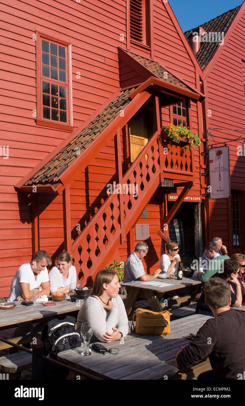 Bergen Norway Bryggen outdoor cafe in back of wooden building relaxing ...