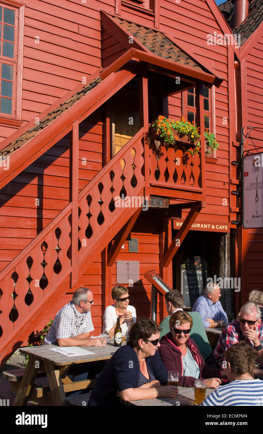 Bergen Norway Bryggen outdoor cafe in back of wooden building relaxing ...