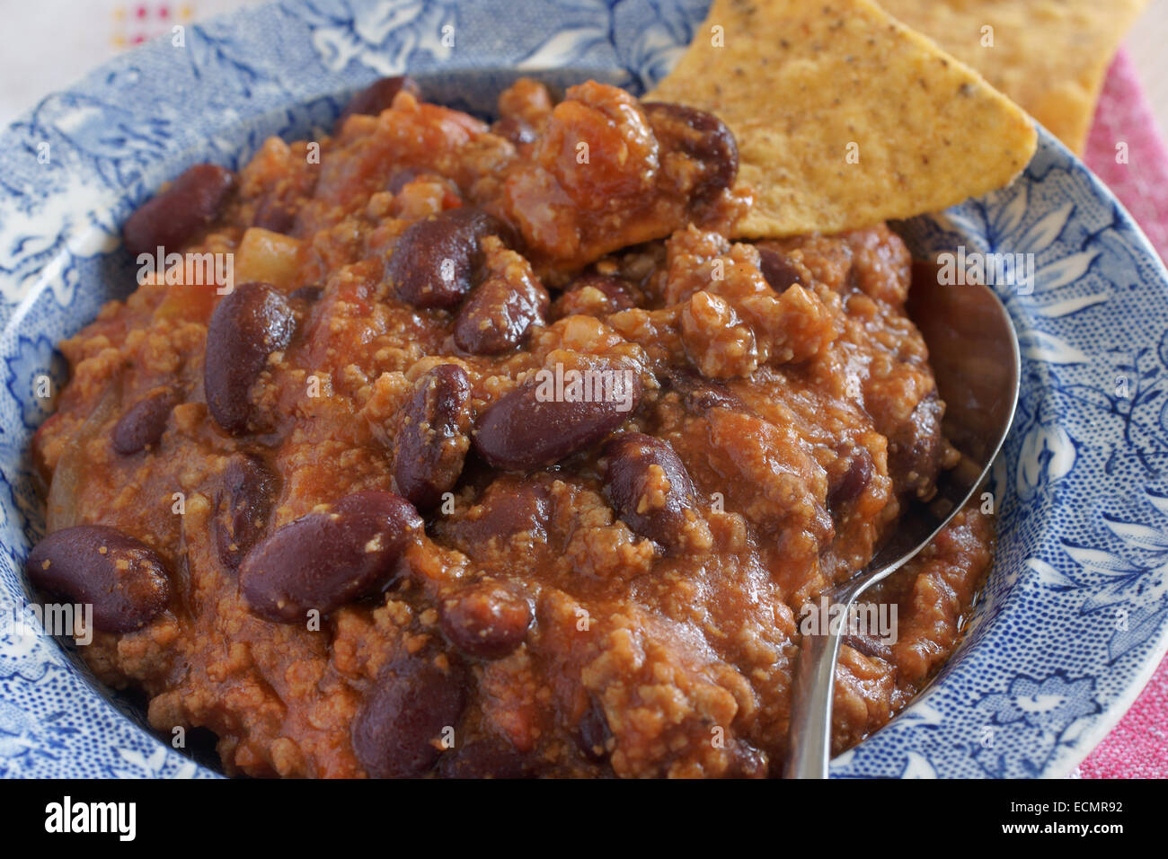 Chilli con Carne served with tortilla corn chips Stock Photo - Alamy