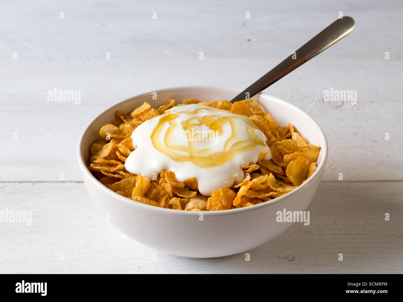 Cornflakes in a bowl with yogurt and honey Stock Photo - Alamy