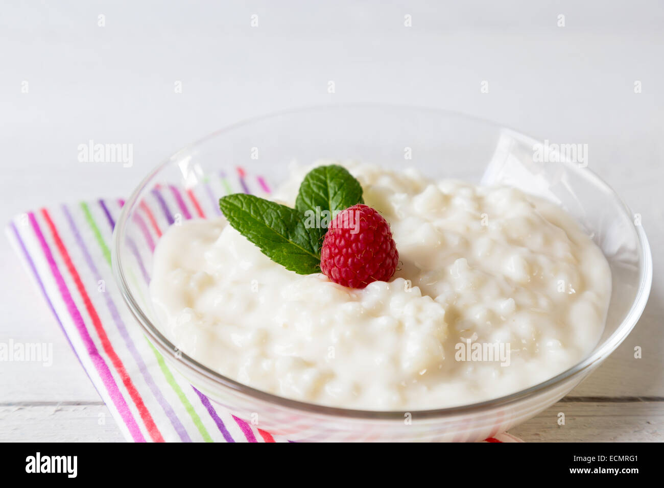 Rice pudding with mint and raspberry Stock Photo - Alamy