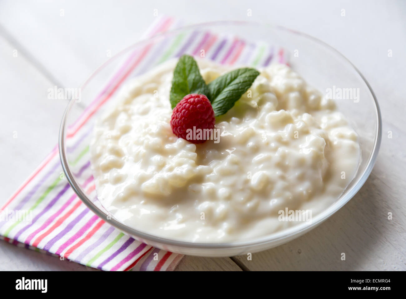 Rice pudding with mint and raspberry Stock Photo - Alamy