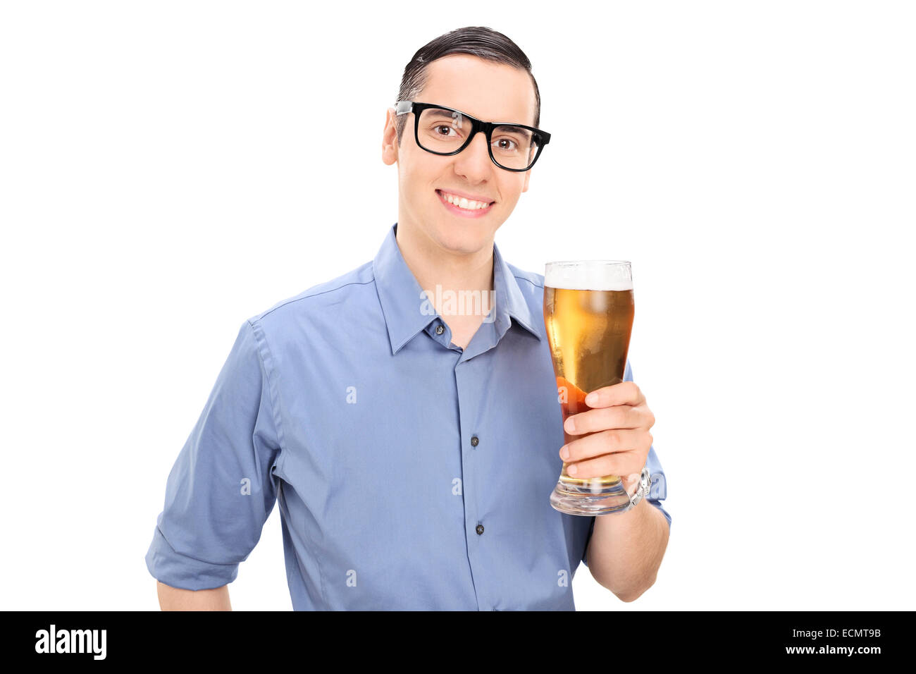 Cheerful young guy holding a pint of beer isolated on white background ...