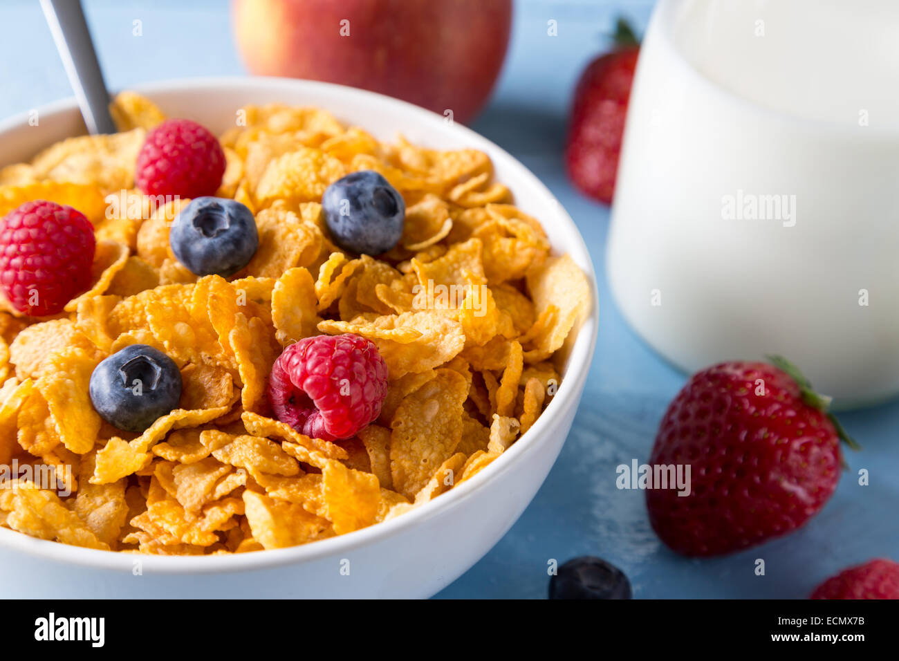 Cornflakes in a bowl with milk and fruits Stock Photo - Alamy