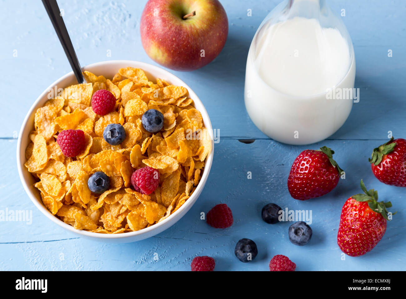 Cornflakes in a bowl with milk and fruits Stock Photo - Alamy