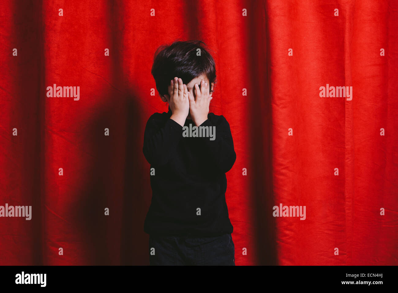 Studio Portrait Of A Three Year Old Boy With His Hands On His Face studio-portrait-of-a-three-year-old-boy-with-his-hands-on-his-face