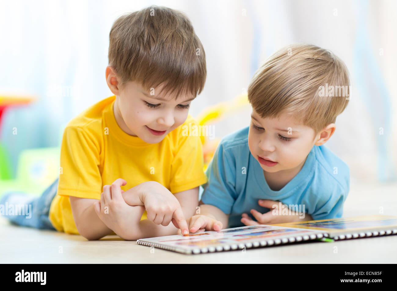 Nursery school children reading book hi-res stock photography and ...