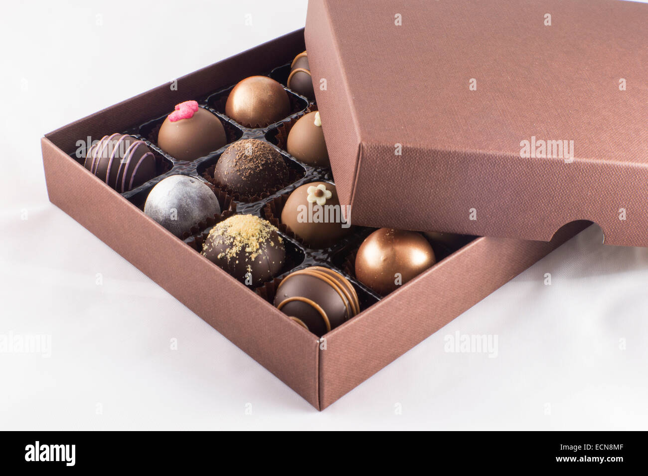 Open chocolate box on a white background Stock Photo - Alamy