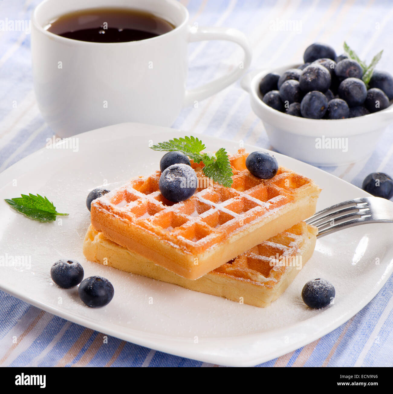 Breakfast - Belgian waffles with tea cup. Selective focus Stock Photo ...