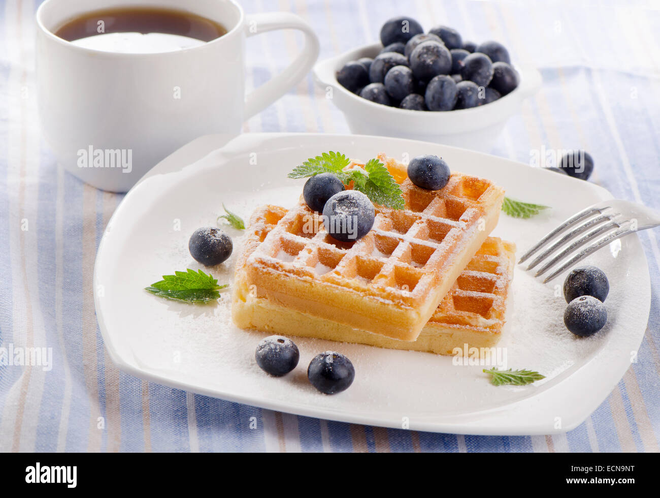 Breakfast - Belgian waffles with tea cup. Selective focus Stock Photo ...