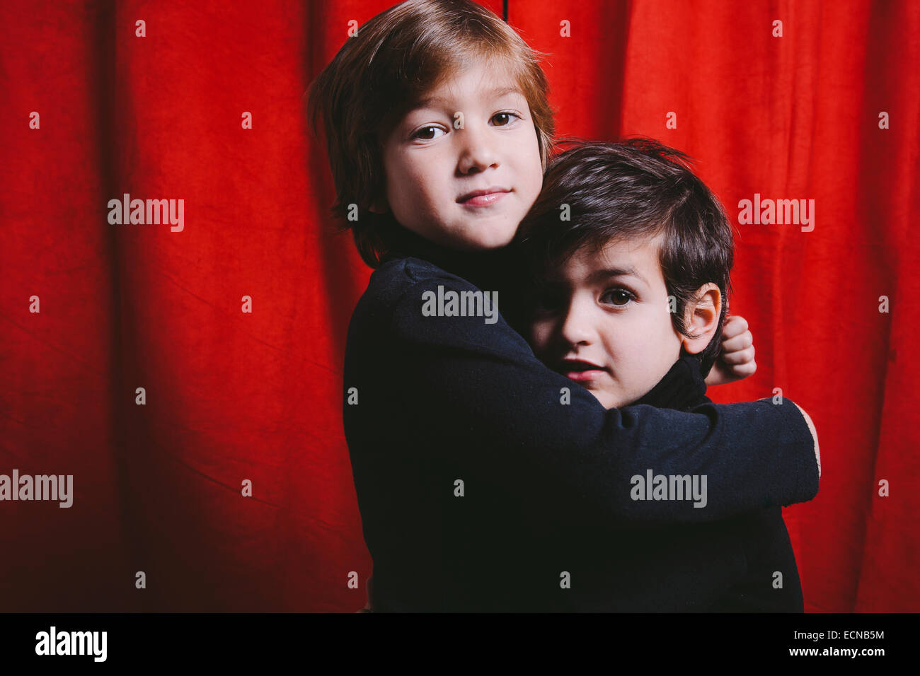Two boys wearing black clothes on a hug Stock Photo - Alamy