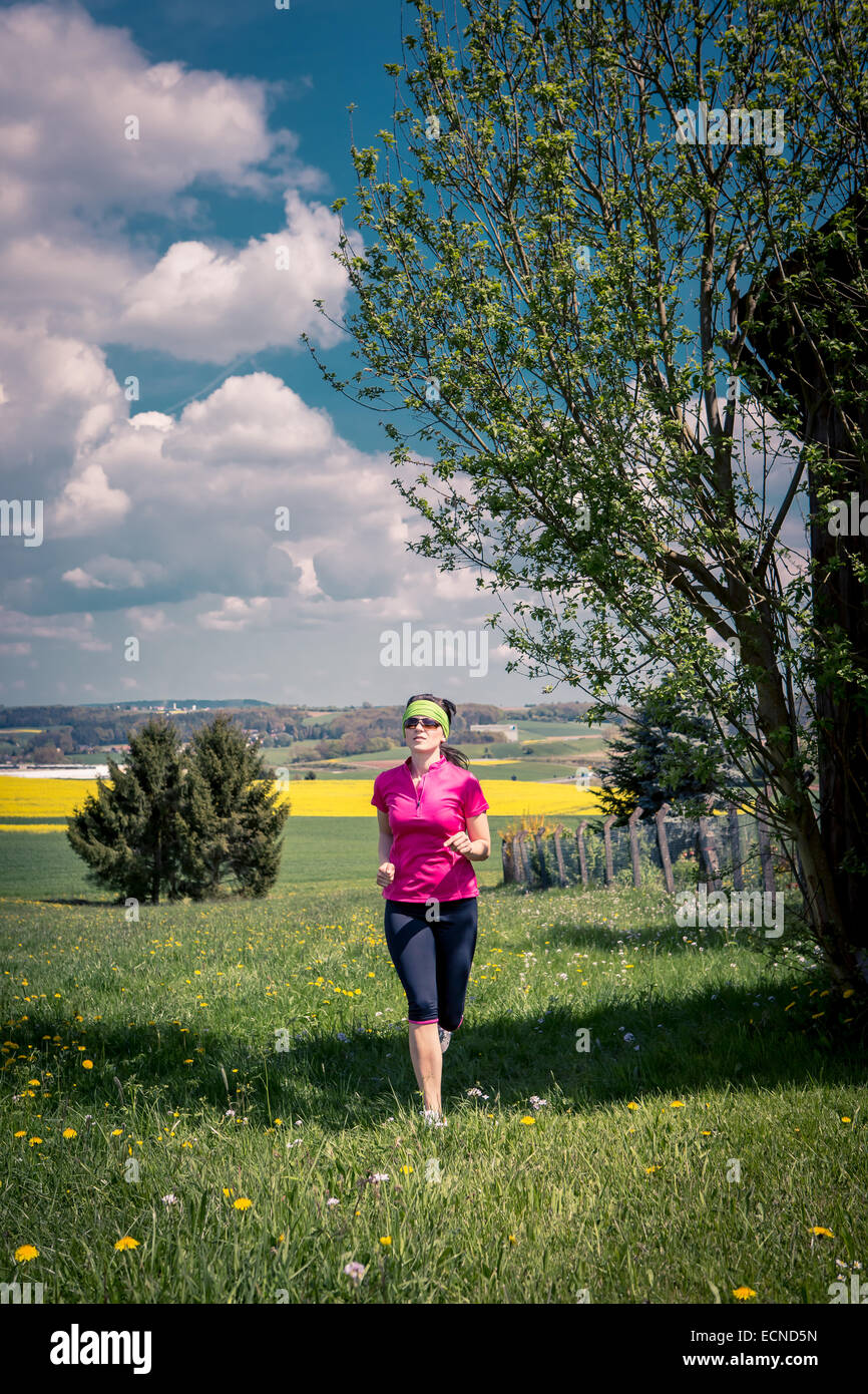 woman jogging through the fields at the springtime Stock Photo - Alamy